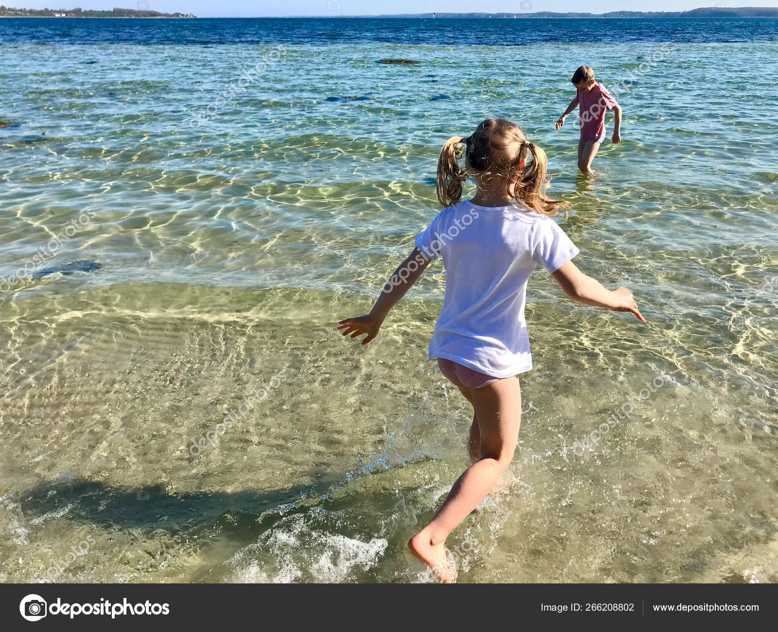 Happy children playing joyful on a beach at sea Stock Photo by ...