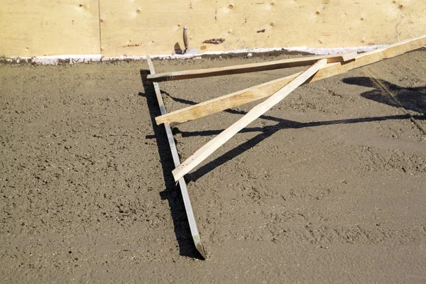 Alignment of fresh concrete slab with a special working tool Stock ...
