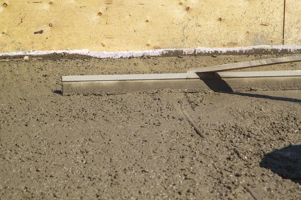 Alignment of fresh concrete slab with a special working tool Stock ...
