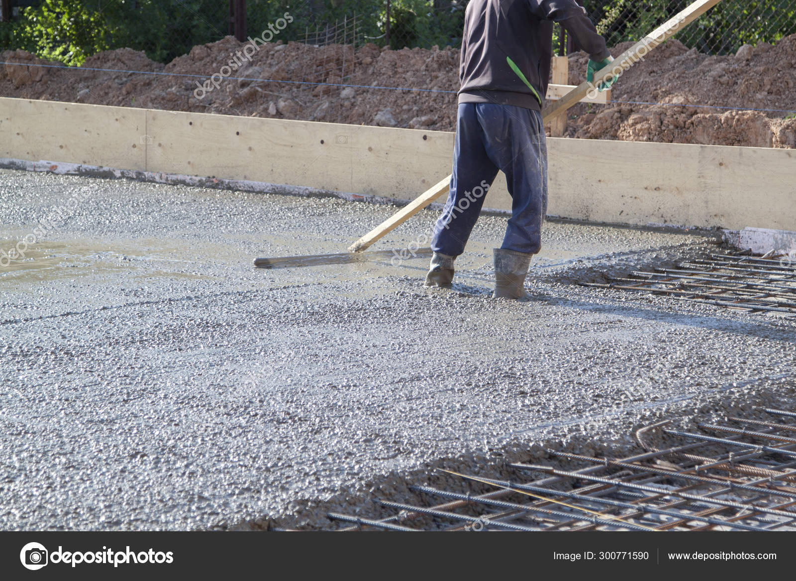 Worker leveling fresh concrete slab with a special working tool Stock ...