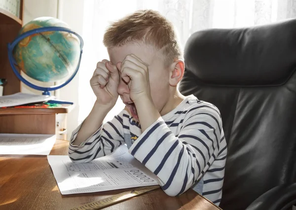 School-age boy crying and screaming while doing homework. the co Stock ...