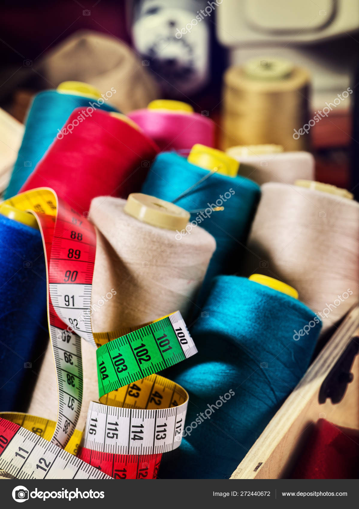 Coil threads for overlock and measuring tape on serger background Stock ...