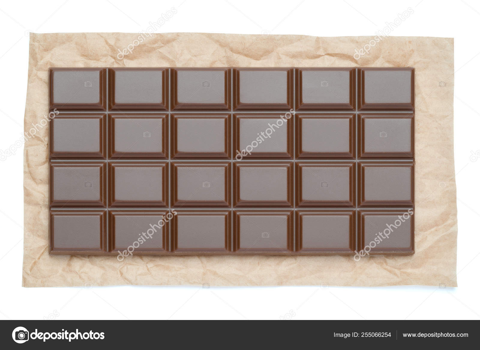 Milk chocolate bar on craft packaging paper isolated on white ...