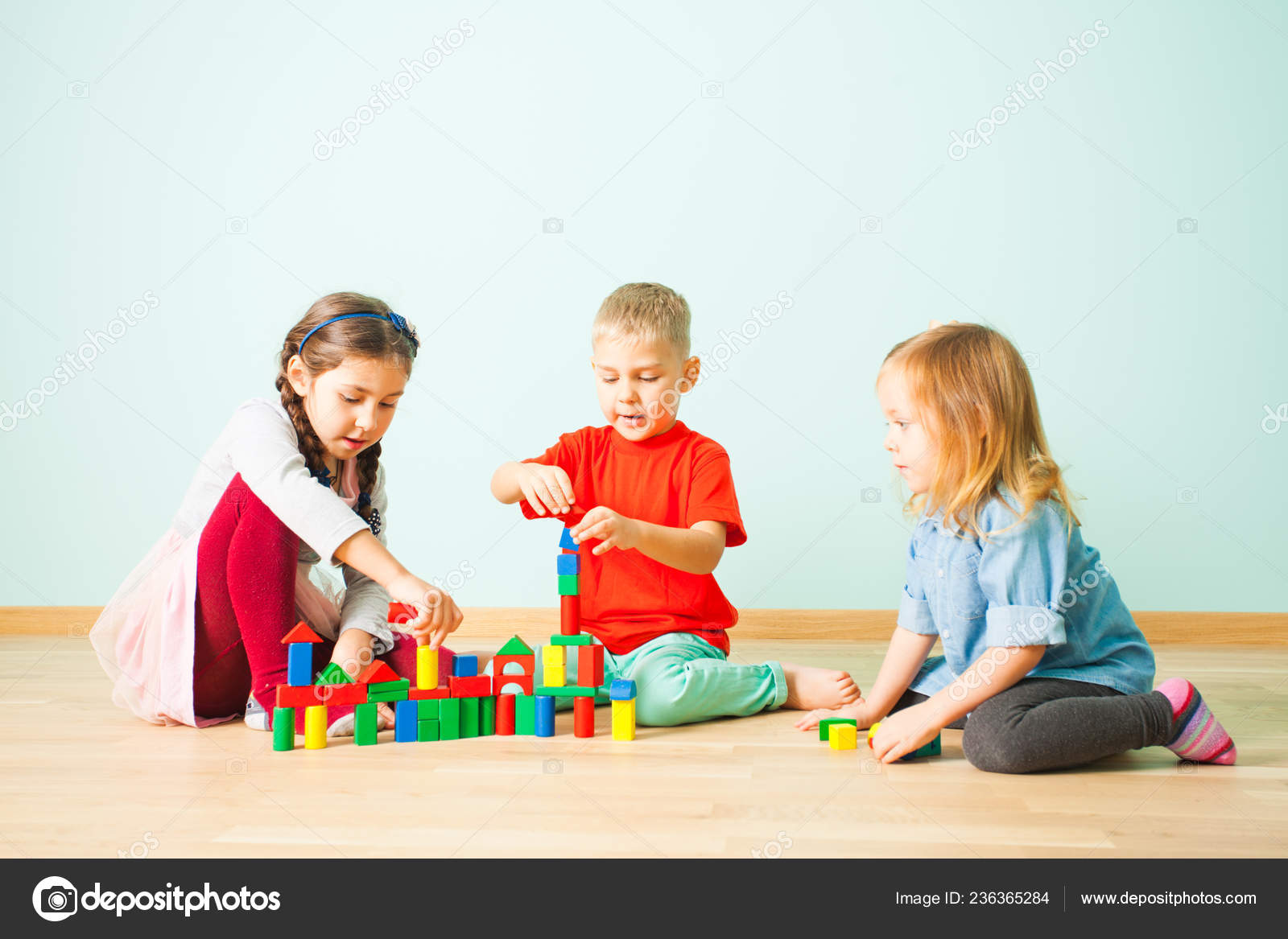 Young kids constructing towers from wooden blocks — Stock Photo ...