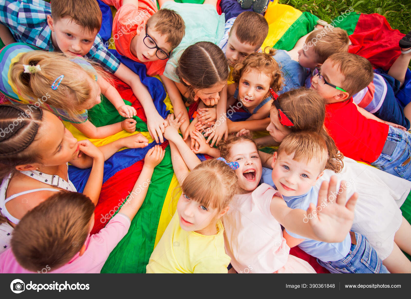 Children laying together in circle on colorful ground Stock Photo by ...