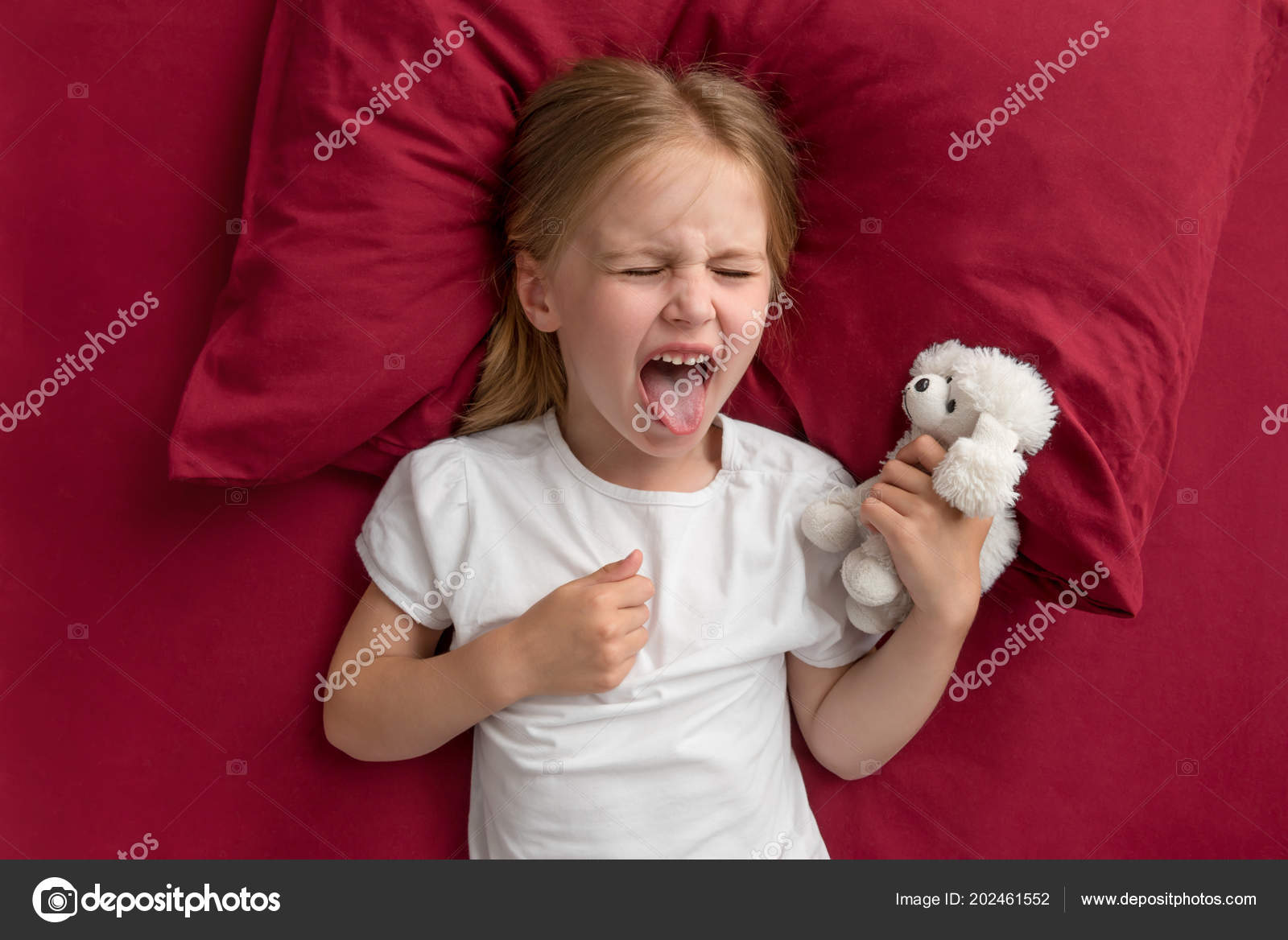 Capricious little girl resisiting bedtime Stock Photo by ©tan4ikk 202461552