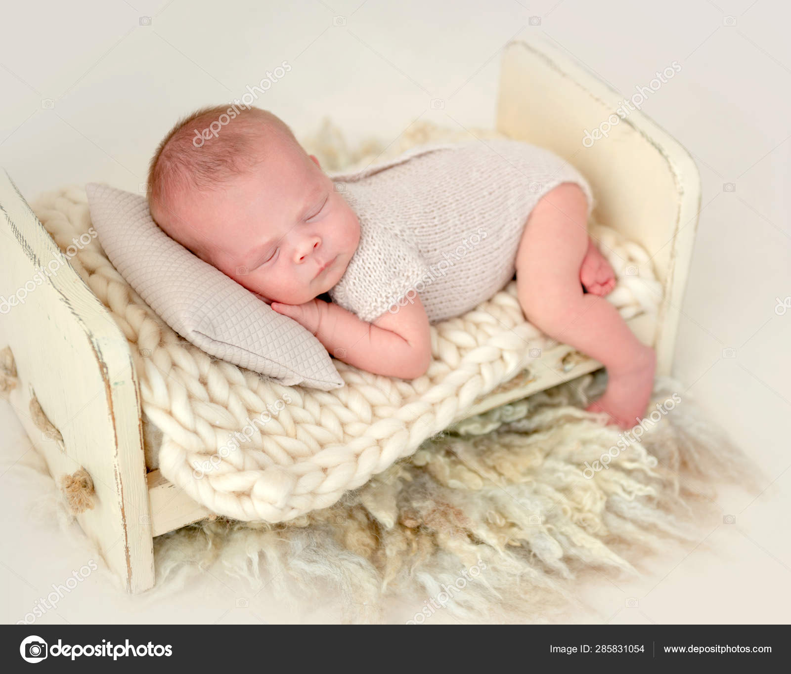 Newborn baby girl sleeping in a little bed — Stock Photo © tan4ikk #285831054