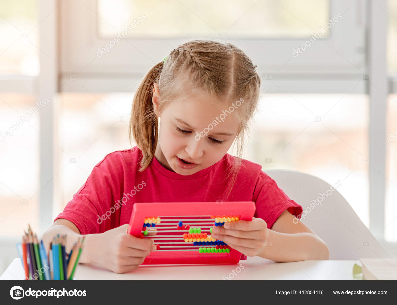 Little girl counting on abacus at school — Stock Photo © tan4ikk #412854416