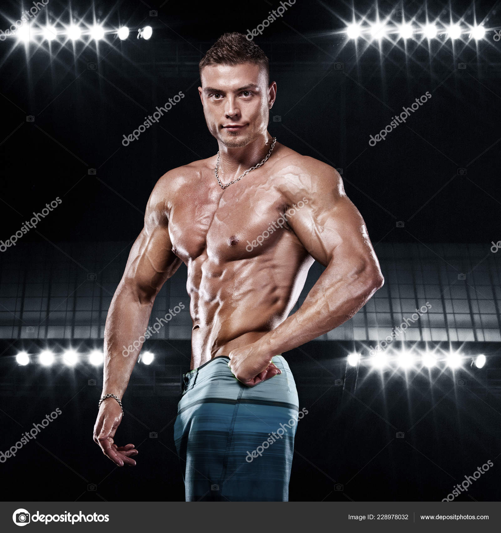 Young Strong Man Bodybuilder Background Lights Stock Photo by ©MikeOrlov 228978032