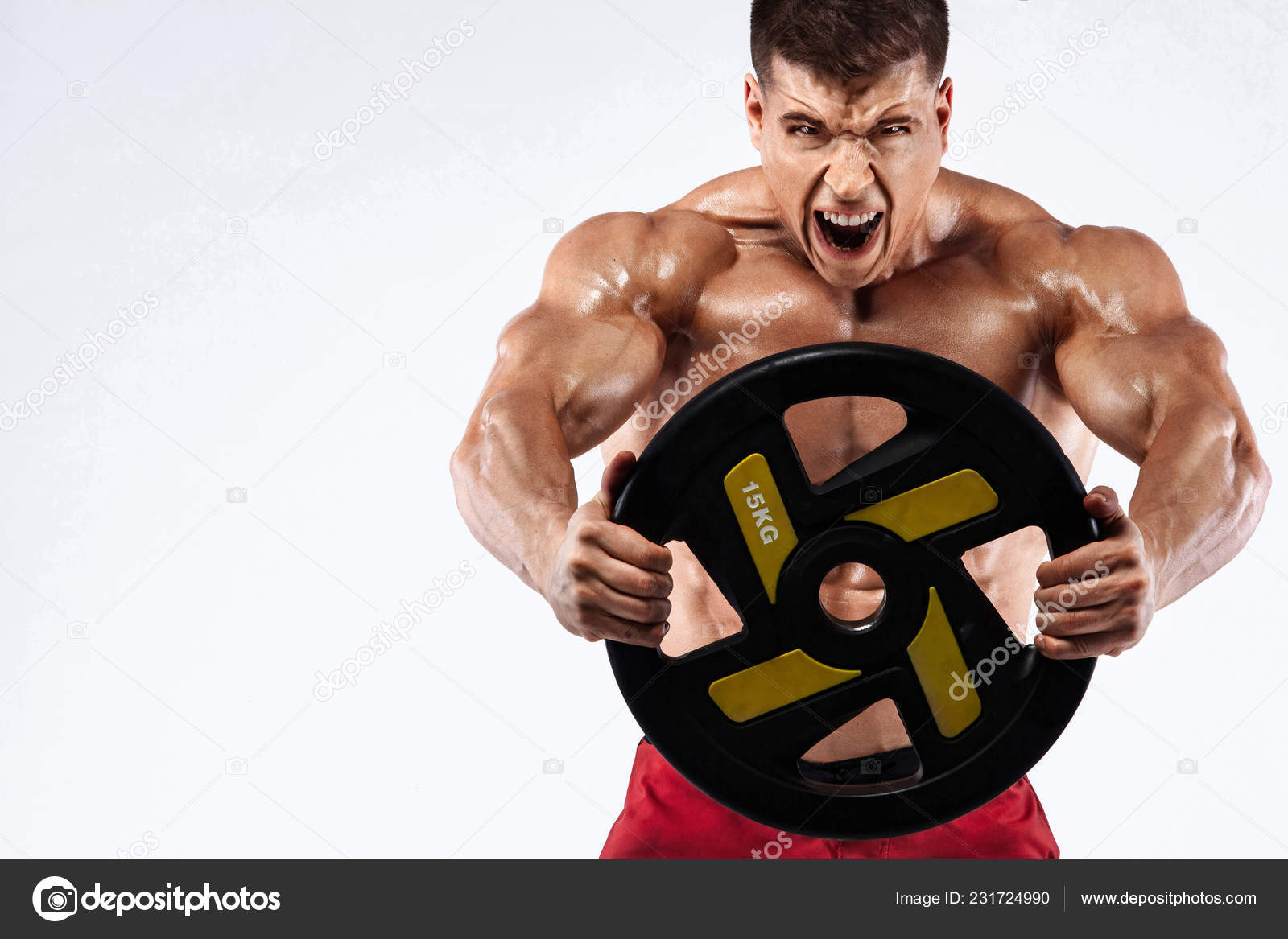 Brutal strong muscular bodybuilder athletic man pumping up muscles on ...