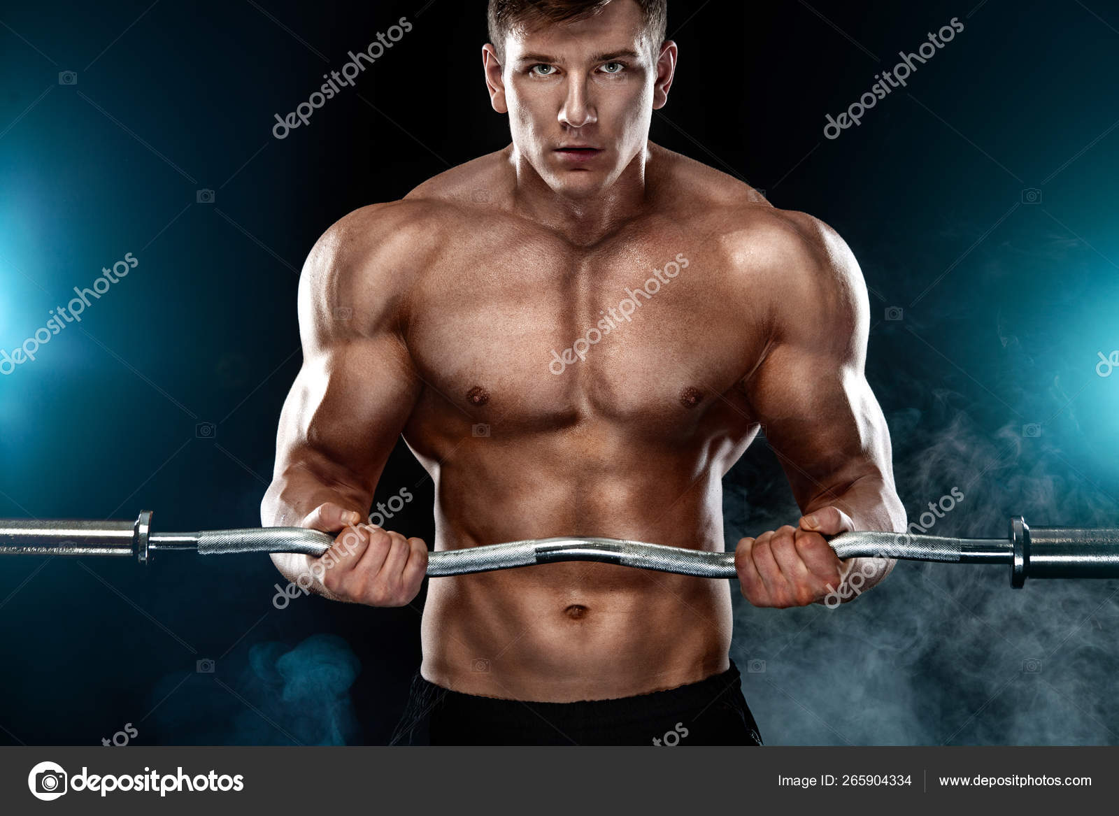 Brutal strong muscular bodybuilder athletic man pumping up muscles with ...