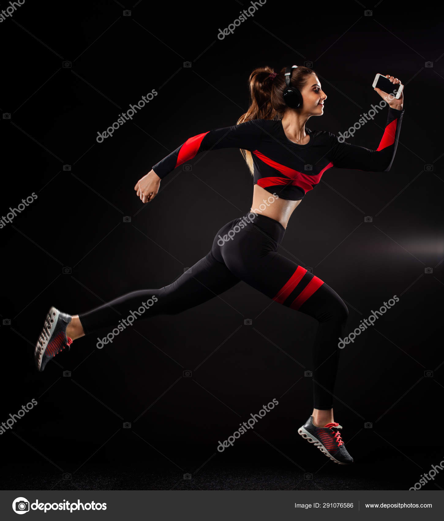 Strong athletic woman sprinter, running on black background wearing in ...