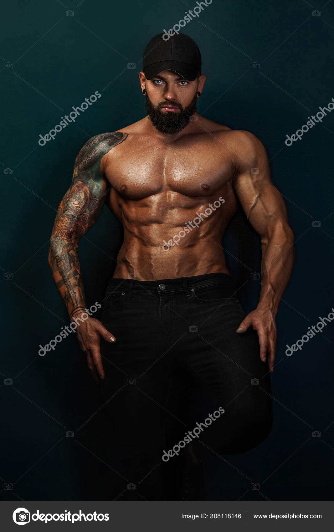 Strong and fit man bodybuilder bare-chested in black baseball cap ...