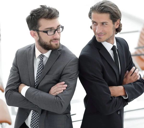 Two men standing back to back and support each other Stock Photo by ...