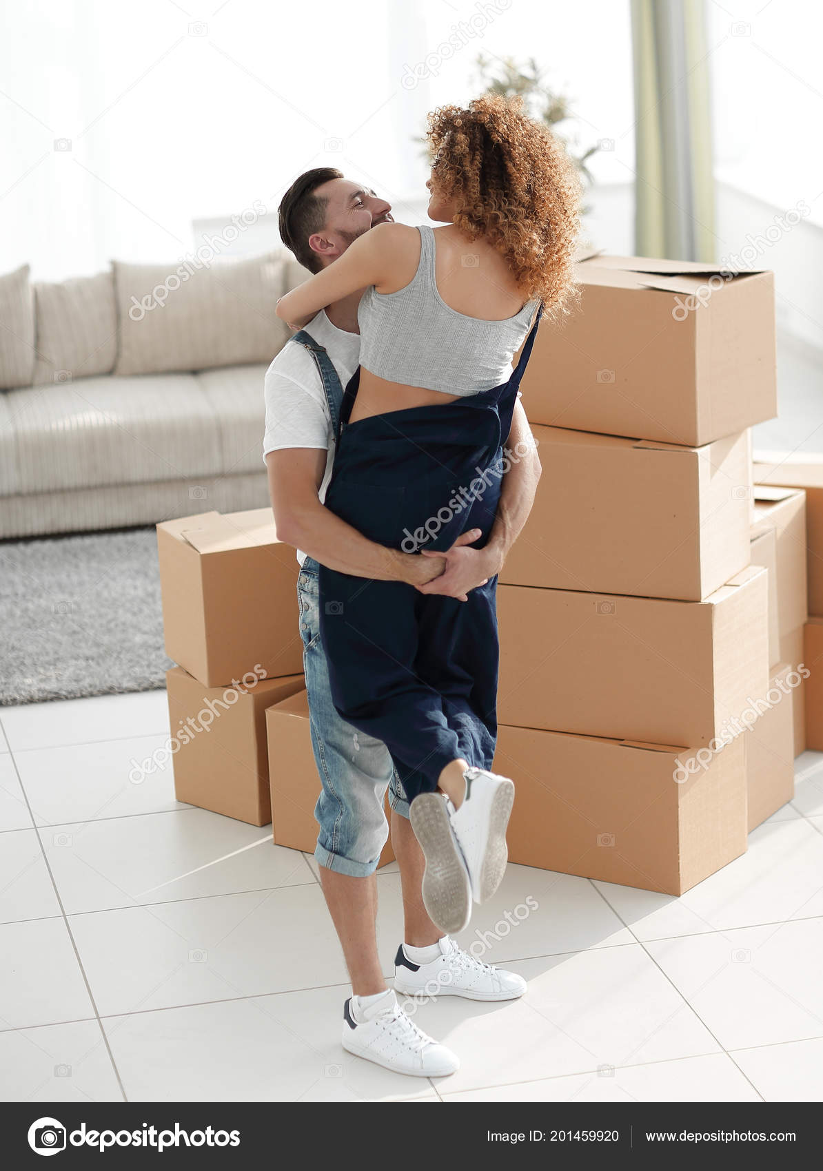 Hugging couple, against the background of boxes Stock Photo by ...