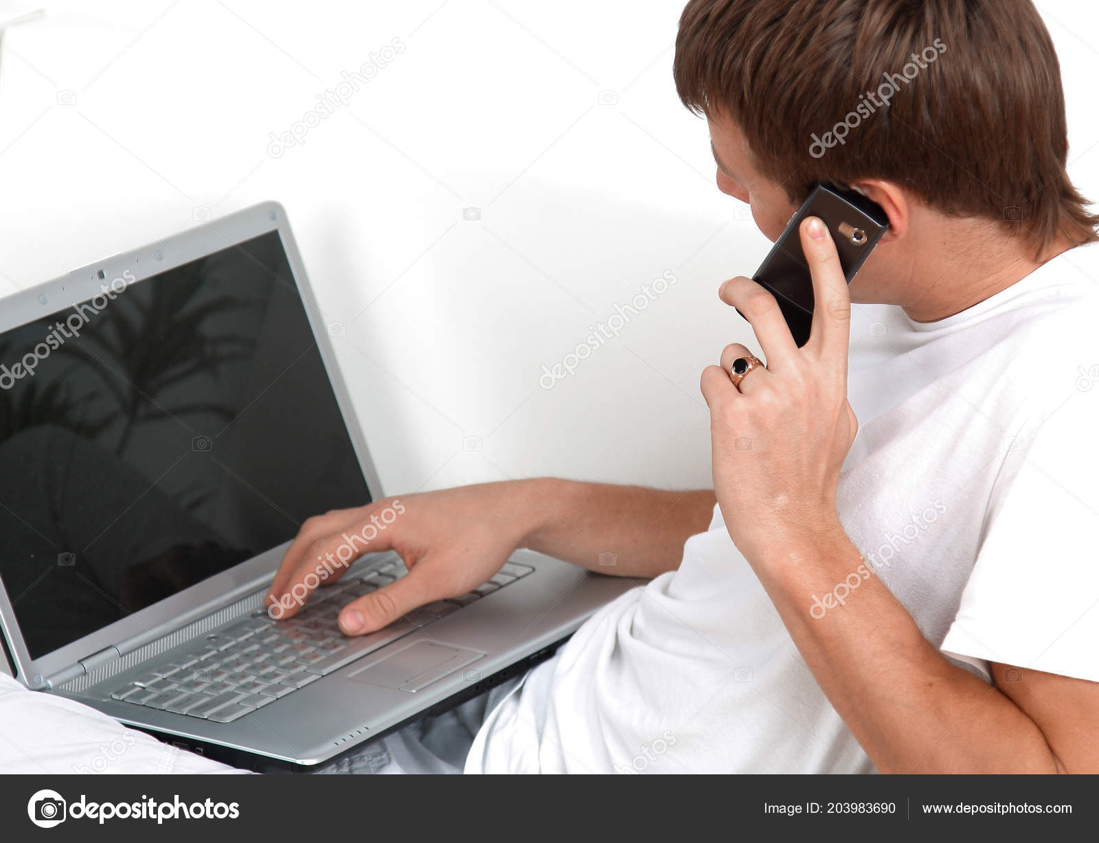 Very focused young man using laptop while sitting comfortably. Stock ...