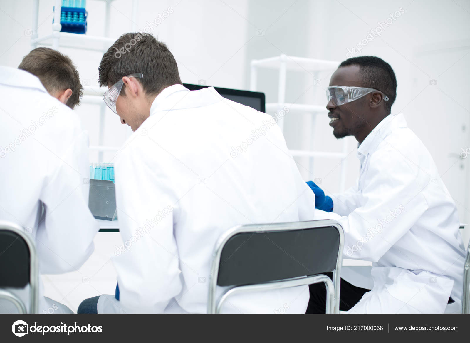 Rear view. a group of scientists at the laboratory table Stock Photo by ...