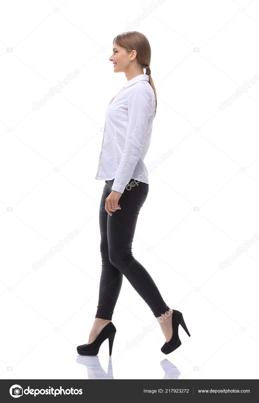 Side view.in full growth.confident young woman is moving forward ...