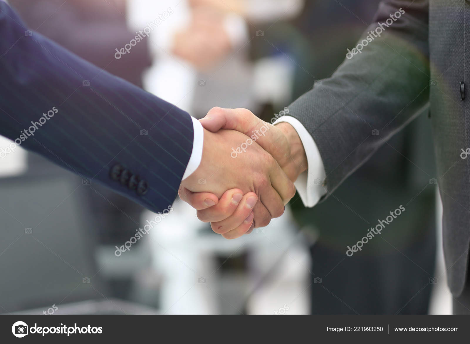 Business partners handshaking over business objects on workplace — Stock Photo © depositedhar ...