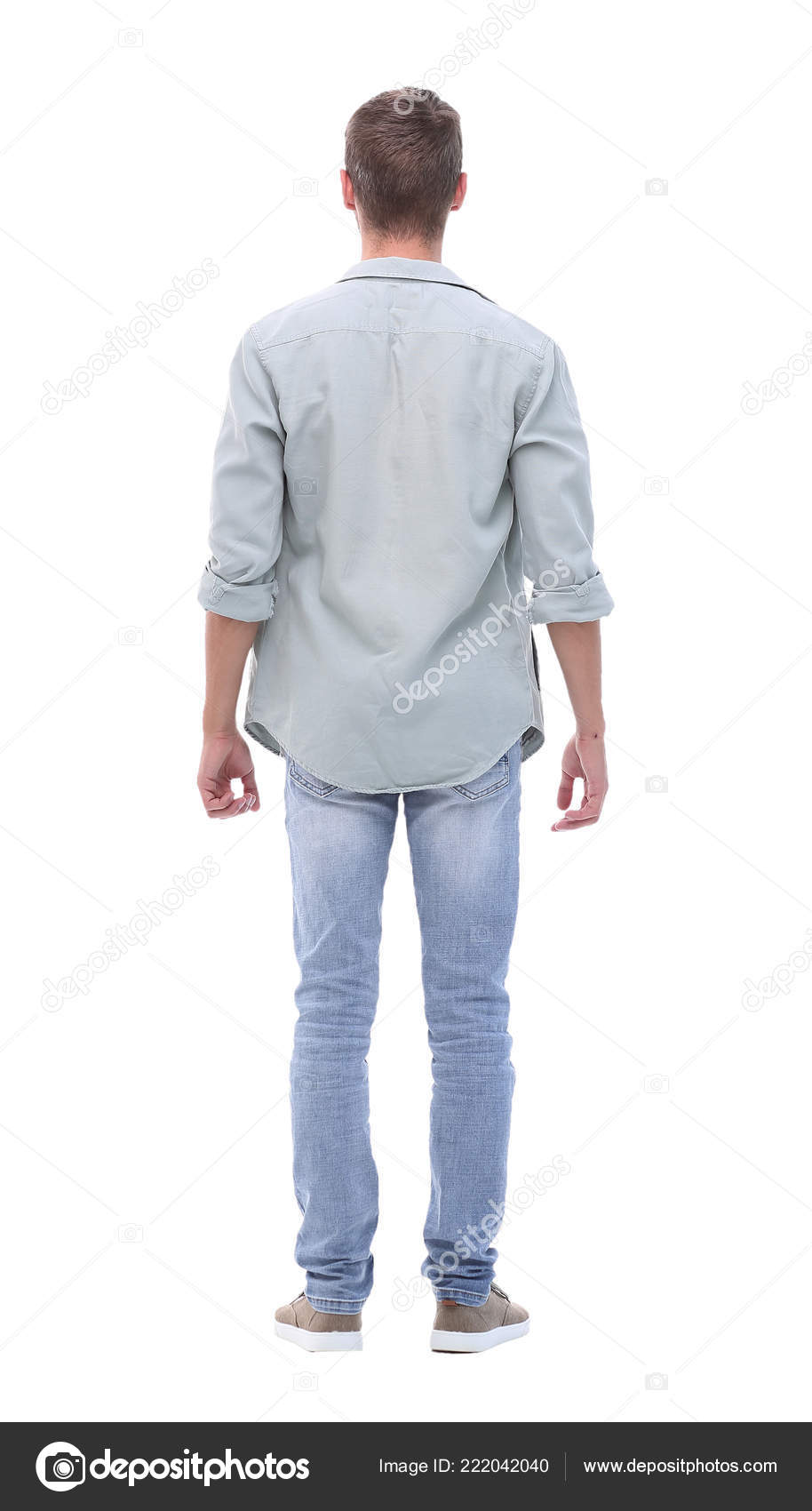 Rear view. young man in jeans looking at copy space Stock Photo by ...