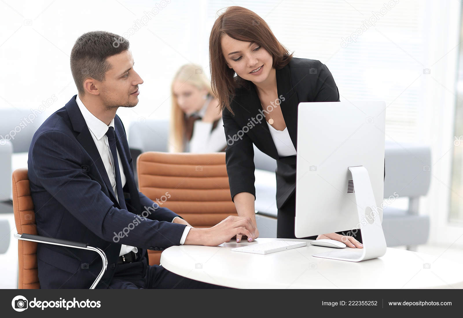 Employees sitting behind a Desk in the office Stock Photo by ...