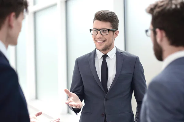 boss talking to employees standing in the office - Stock Image - Everypixel