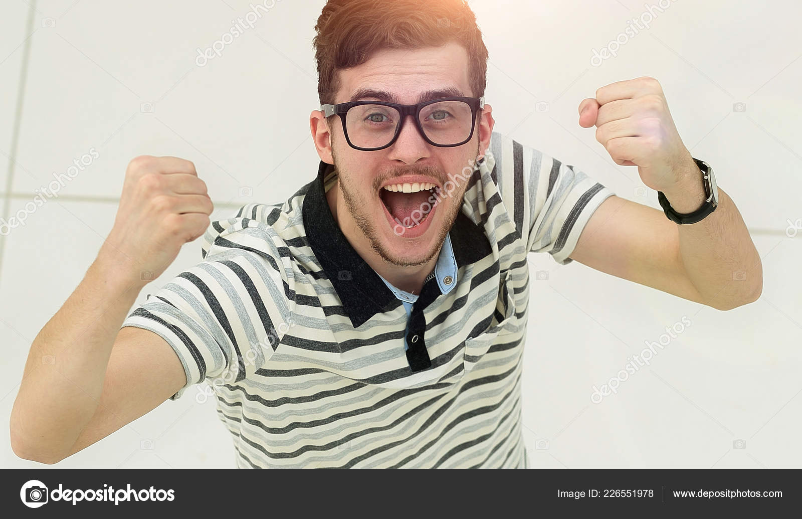 Closeup.the view from the top.jubilant young man looking at the camera ...
