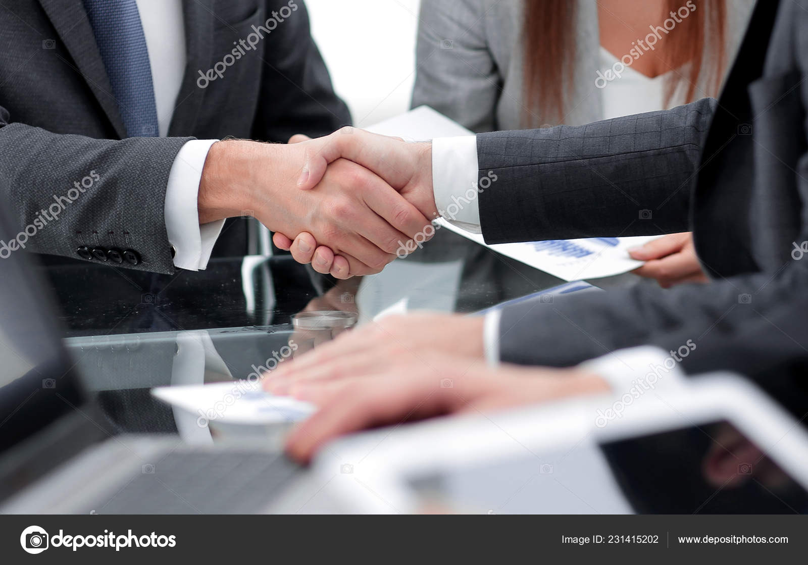 Handshake partners at the Desk Stock Photo by ©depositedhar 231415202