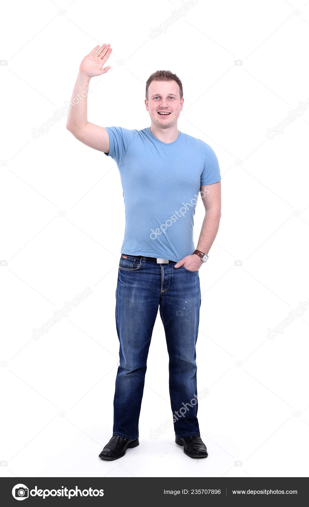 Smiling young man raising hand up Stock Photo by ©depositedhar 235707896
