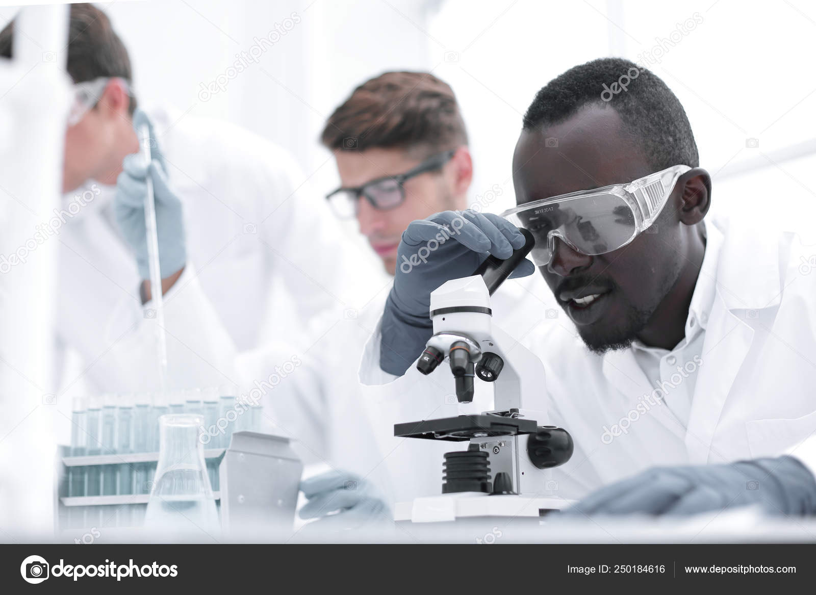 Close up.a multinational group of scientists is conducting research ...