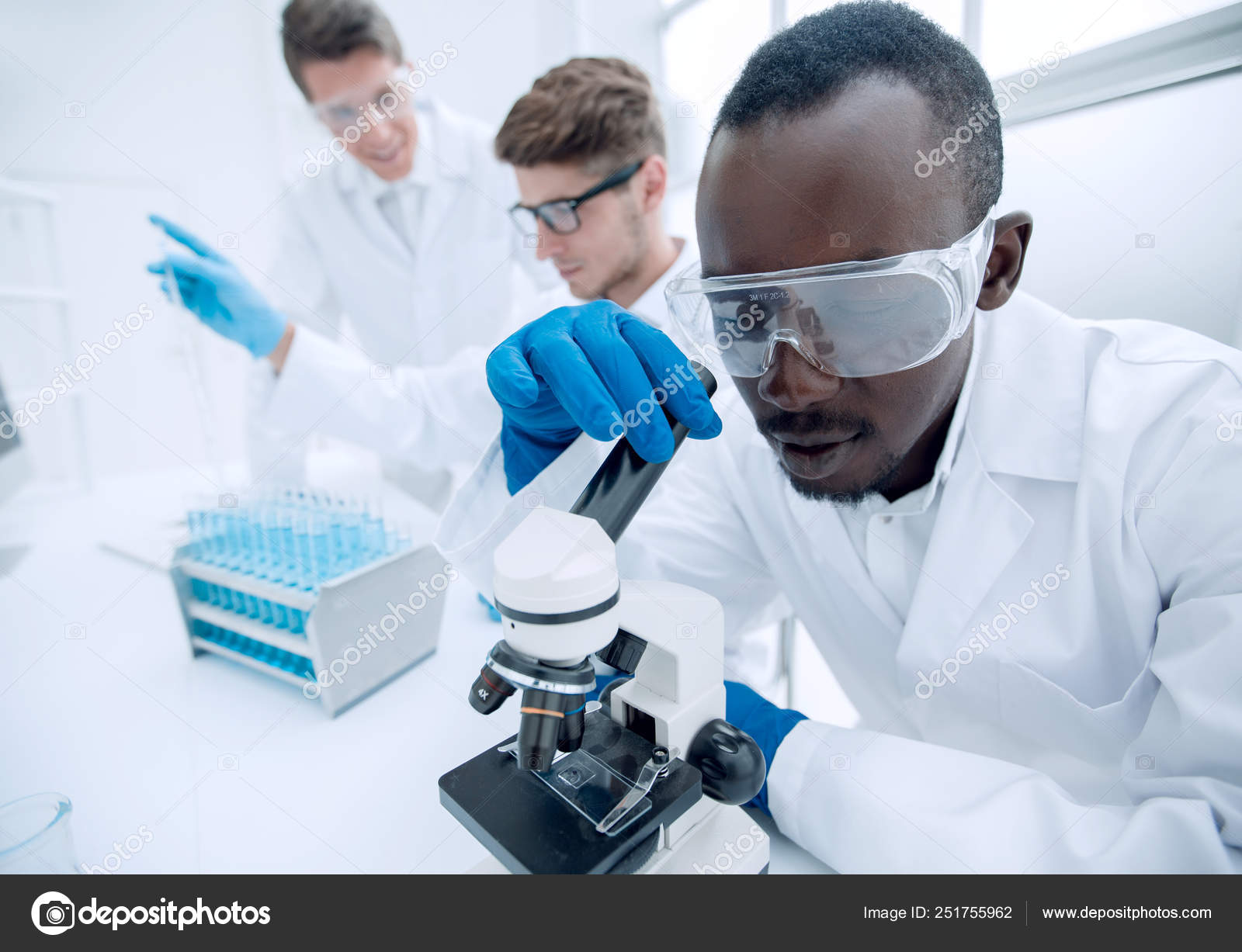 Modern scientist uses a microscope in a laboratory — Stock Photo ...