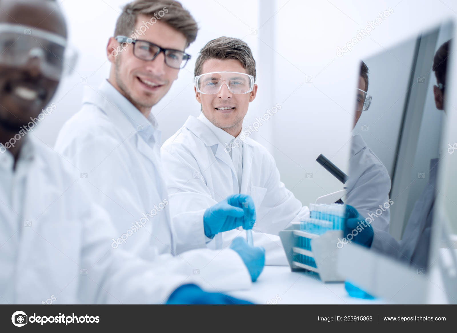 Successful group of scientists sitting at their Desk Stock Photo by ...