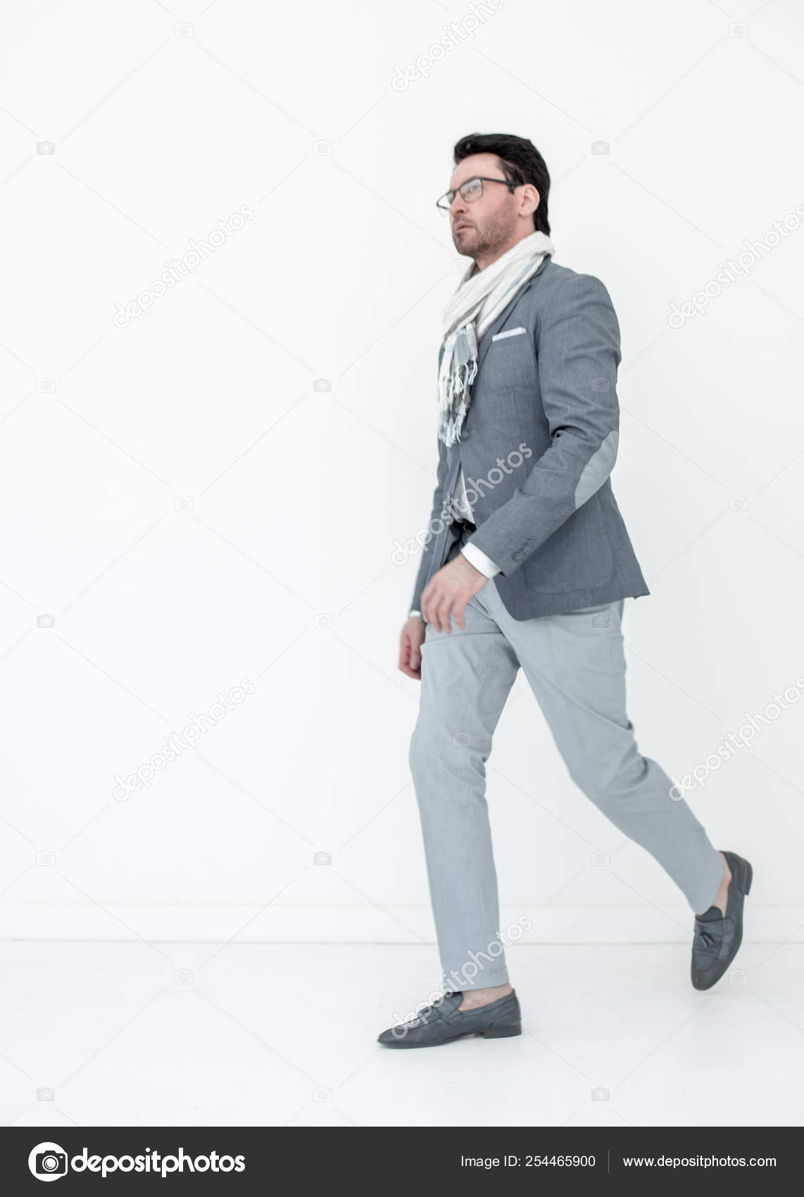 Side view .a serious man confidently striding forward Stock Photo by ...