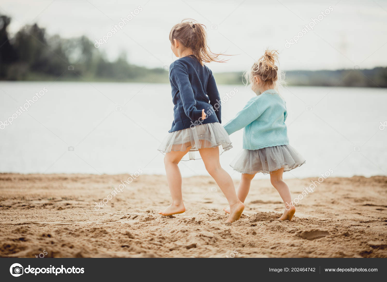 Two sisters playing on the shore of the lake Stock Photo by ©JuliaSha ...