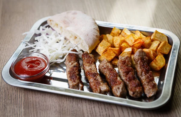 Traditional Serbian roasted meat dish served with fried potato.Exotic ...