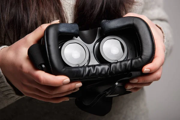 Woman holding modern virtual reality glasses for mobile game ...