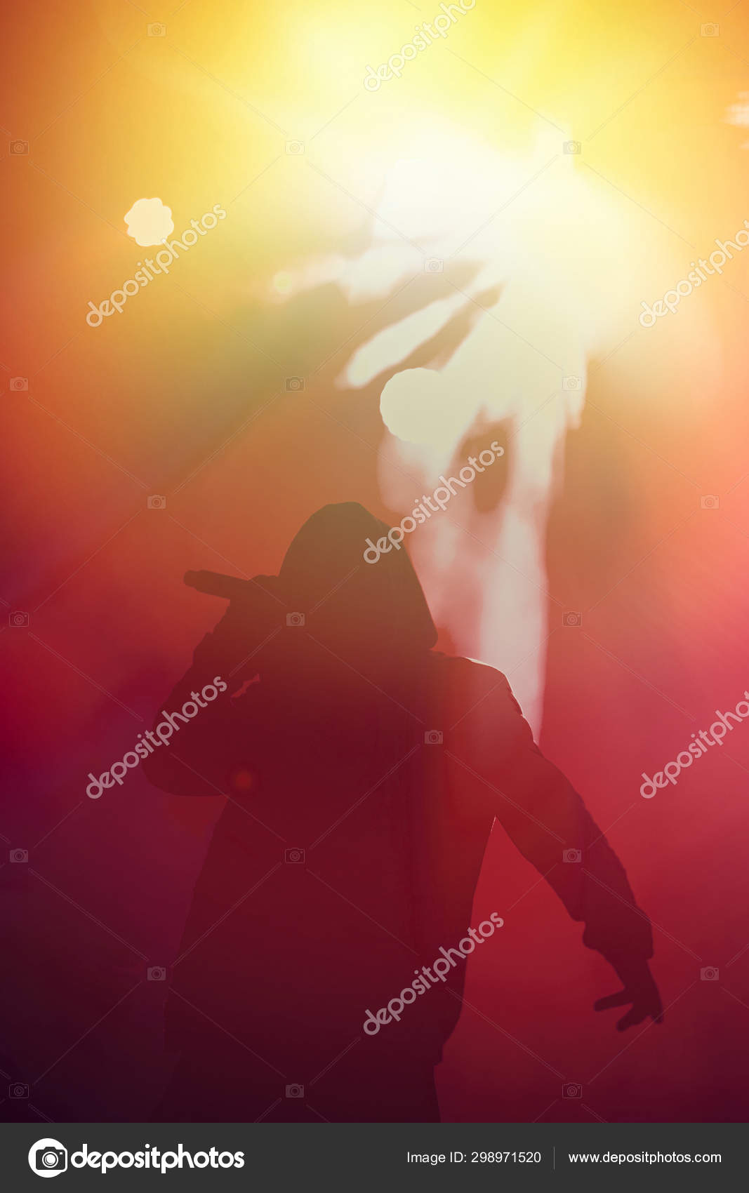 Rap singer on concert stage in bright lights Stock Photo by ...
