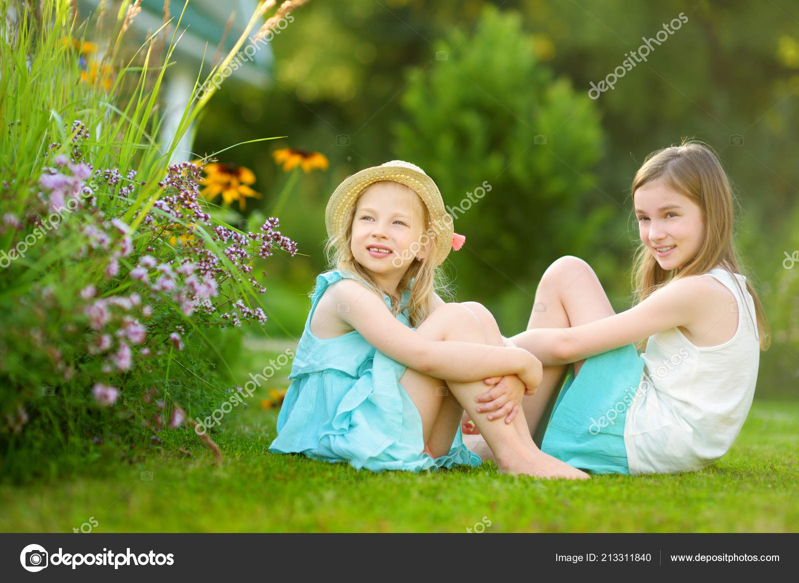 Two Cute Little Sisters Having Fun Together Grass Sunny Summer Stock Photo by ©MNStudio 213311840