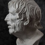 Gypsum copy of ancient statue Seneca head on dark textured background ...