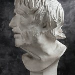 Gypsum copy of ancient statue Seneca head on dark textured background ...