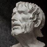 Gypsum copy of ancient statue Seneca head on dark textured background ...