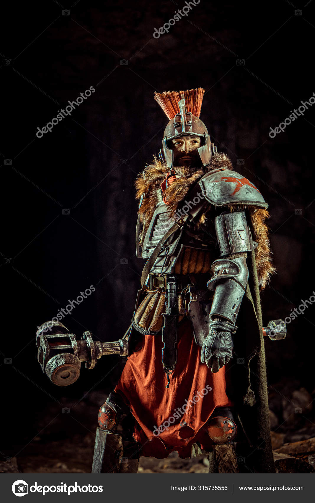 Powerful knight in the armor with the hammer. Dungeon on the background ...