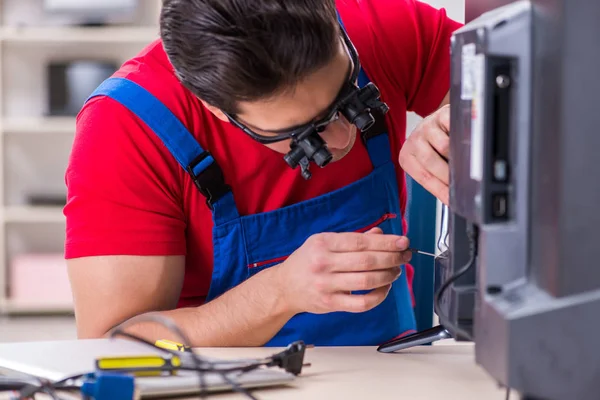 Professional repair engineer repairing broken tv - Stock Image - Everypixel