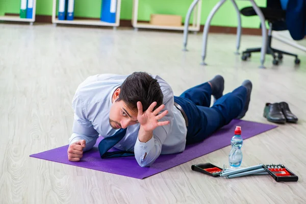 Employee doing exercises during break at work - Stock Image - Everypixel