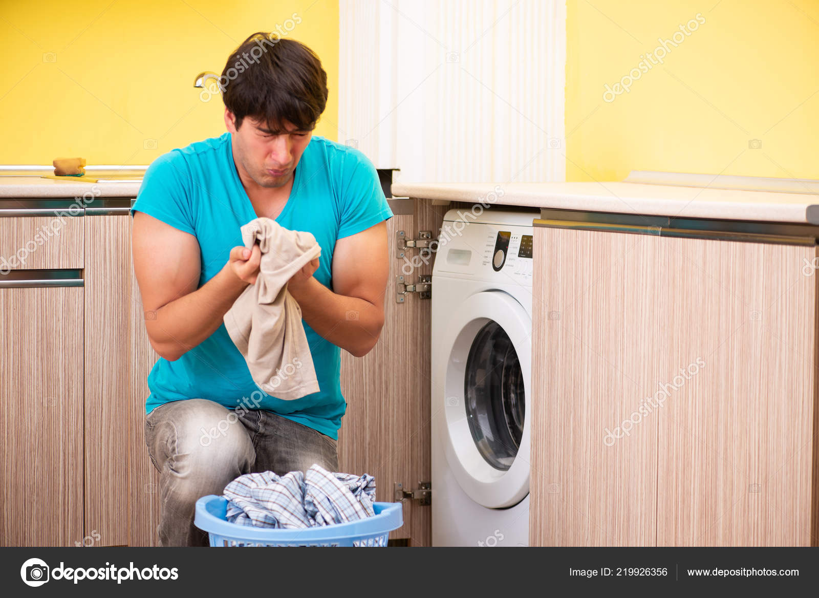 Young husband man doing laundry at home Stock Photo by ©Elnur_ 219926356