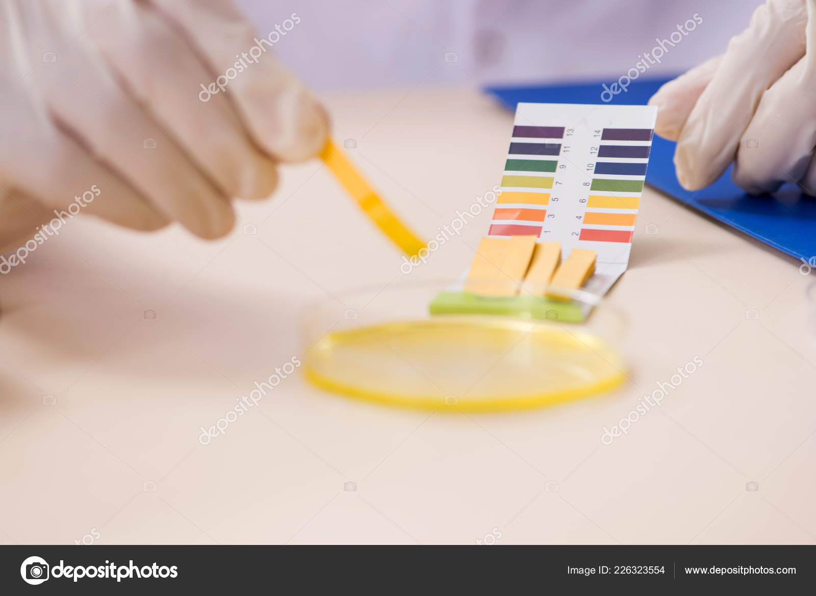 Chemist in the lab checking with ph strips — Stock Photo © Elnur ...