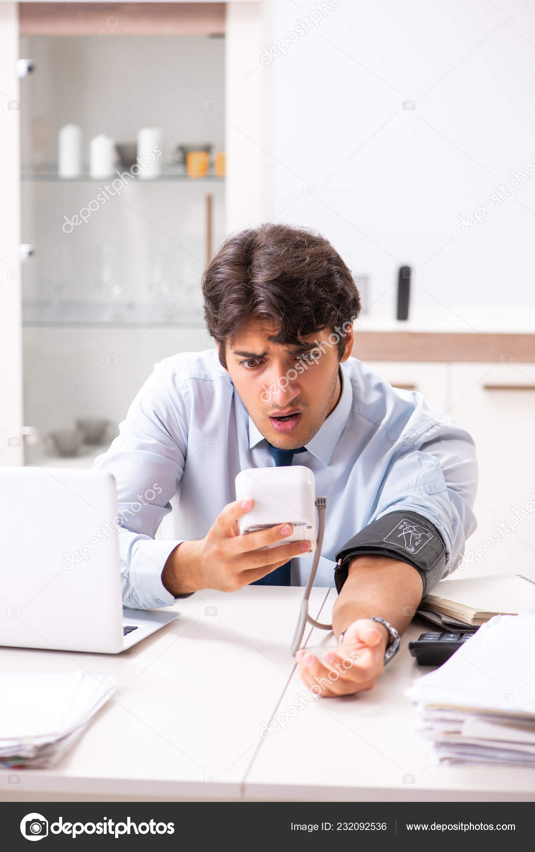Man under stress measuring his blood pressure — Stock Photo © Elnur ...