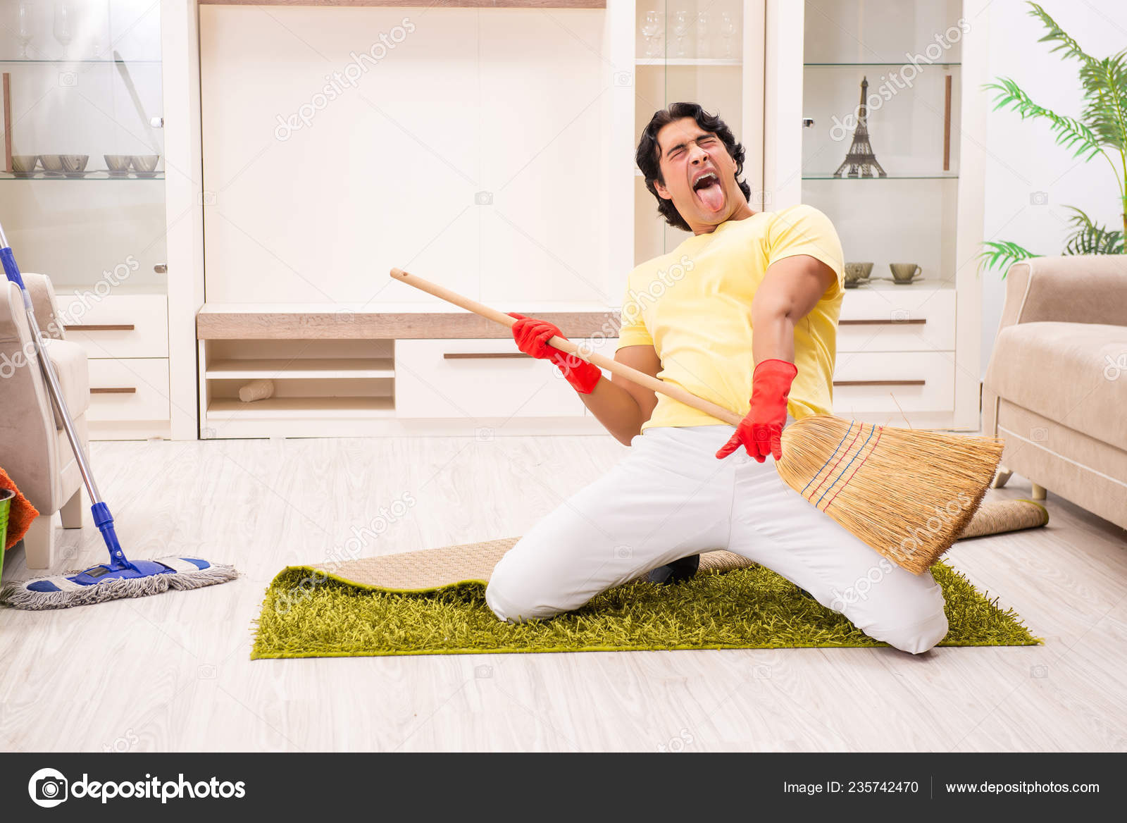 Young handsome man doing housework Stock Photo by ©Elnur_ 235742470