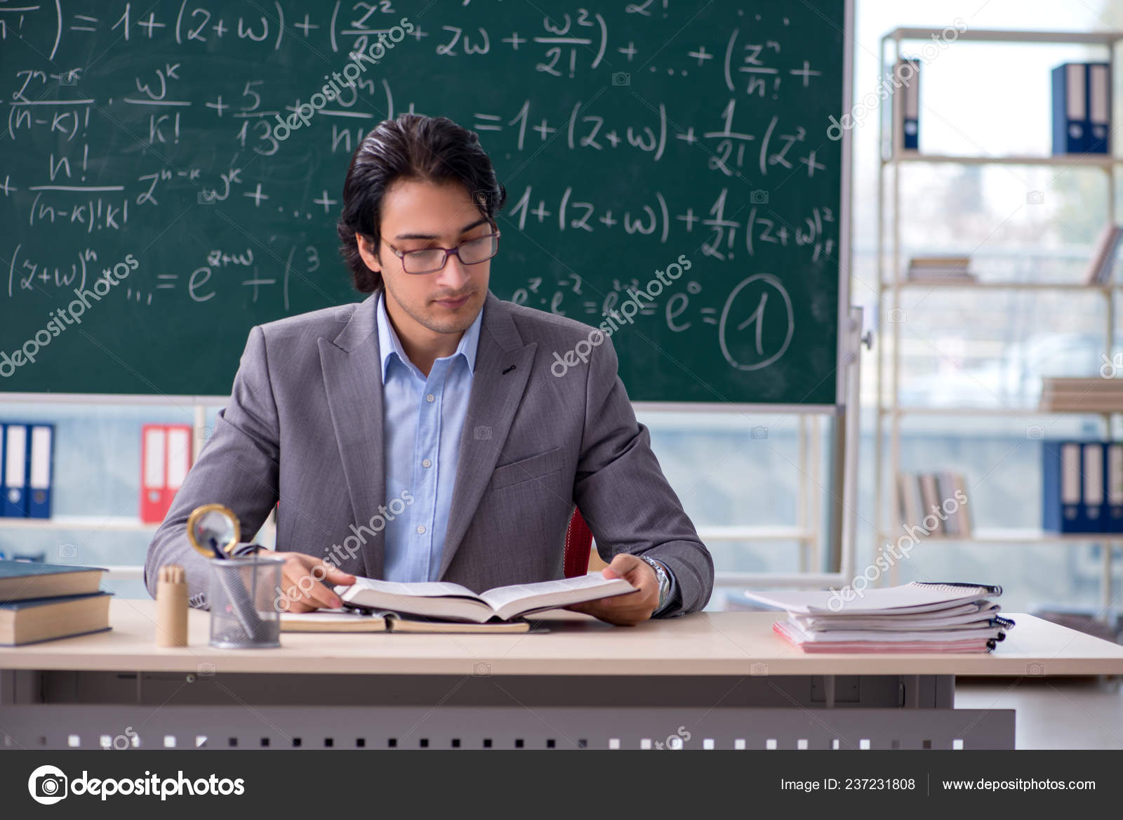 Young handsome math teacher in classroom — Stock Photo © Elnur_ #237231808