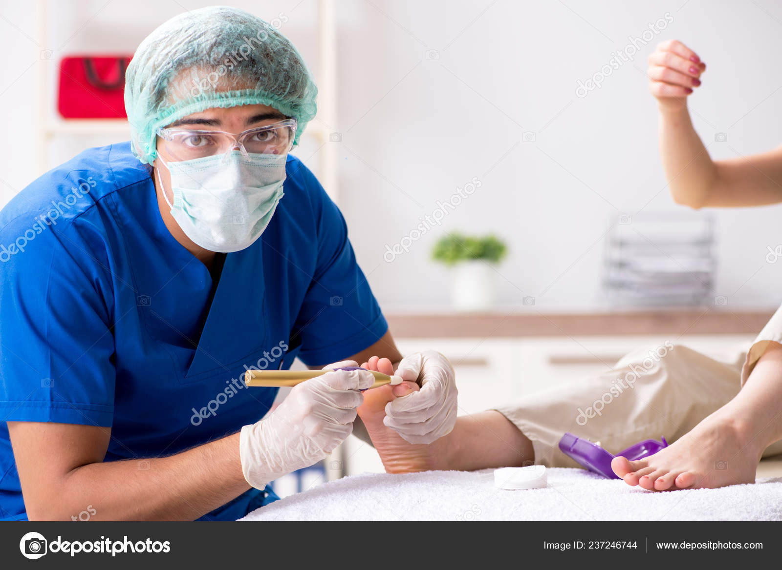 Podiatrist treating feet during procedure Stock Photo by ©Elnur_ 237246744